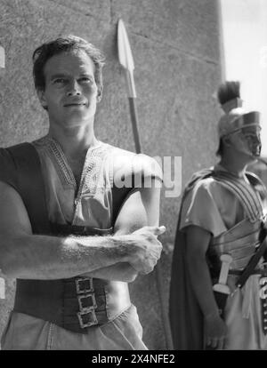 WILLIAM WYLER looks at a drawing made by CHARLTON HESTON during a break ...