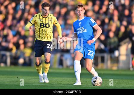 Hector Kyprianou (22 Peterborough United) holds off Tommy Backwell (26 ...