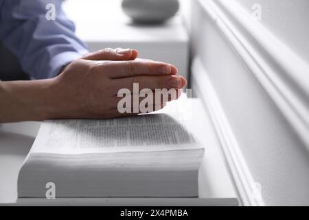 Religion. Christian woman praying over Bible indoors, closeup Stock ...