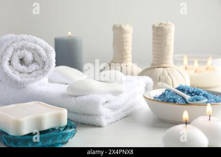 Composition with spa herbal bag, burning candle, sea salt and massage ...