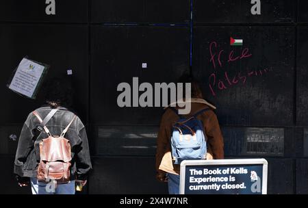 Pro-Palestine graffiti on a gate at an entrance to Trinity College in ...