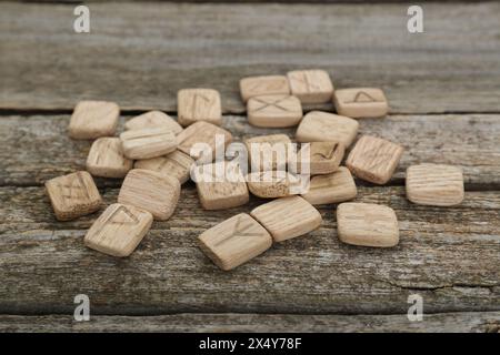 Pile of runes with different symbols on wooden table Stock Photo - Alamy