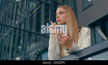 Girl using mobile phone near street Stock Photo - Alamy