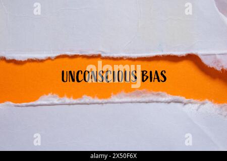 Unconscious bias words written on wooden block with red background. Conceptual unconscious bias ...