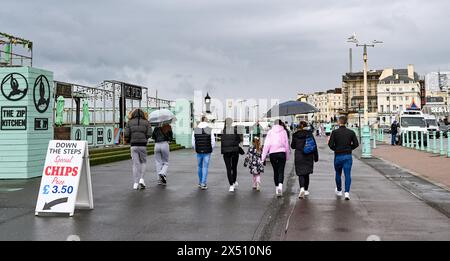 Brighton UK 6th May 2024 - It's umbrella weather for visitors on ...