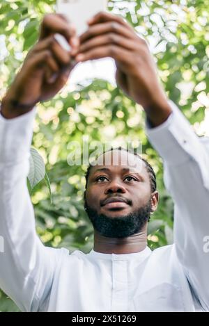 Young urban man with smarphone outdoors on background of St Basils ...