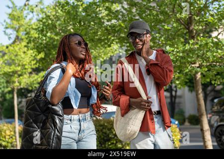 Surprised couple with stylish sunglasses on light background Stock ...