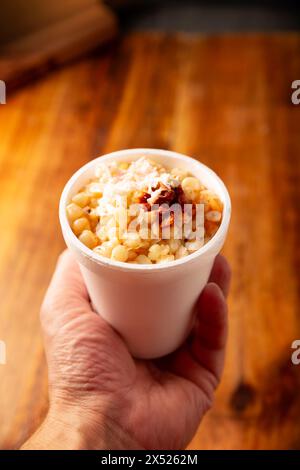 Holding a cup of corn at a street food stand Stock Photo - Alamy