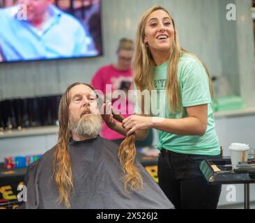 Dennis Helmer of Winslow, New Jersey has his hair cut for donation by ...