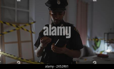 African american policeman taking notes on tablet on city street Stock ...