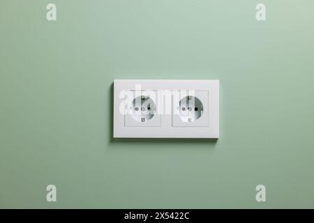 Electric power sockets on light grey wall indoors, space for text Stock ...
