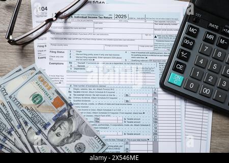 Payroll. Tax return forms and dollar banknotes on wooden table, flat ...