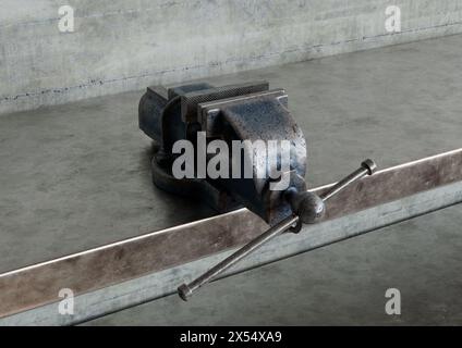 An industrial cast iron bench vice grip mounted on a metal workbench ...