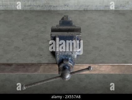 An industrial cast iron bench vice grip mounted on a metal workbench ...