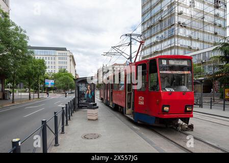 Traditional red electric trams taking passengers around the streets of ...