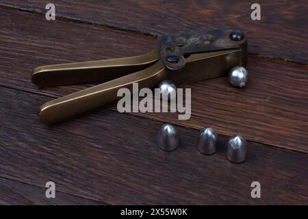 old west bullet mold with bullets for revolver. Isolated on white ...