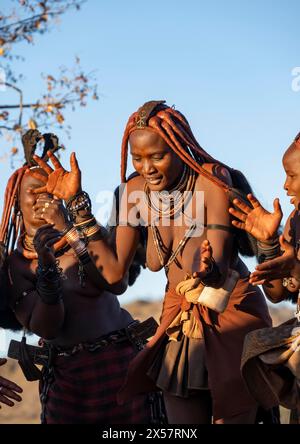 Traditional Himba woman clapping, music and dance, portraits, in the ...