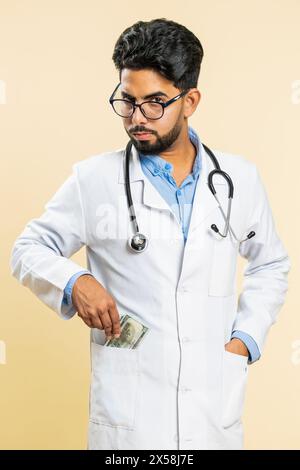 Man giving bribe to a indian doctor refusing the money, isolated on ...