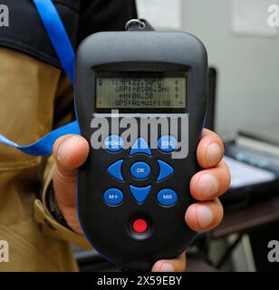 Radiation detector testing. Dosimetrist hands adjusting a portable ...