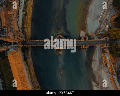 An aerial view of Ponte Scaligero bridge in Italy on blue sky ...