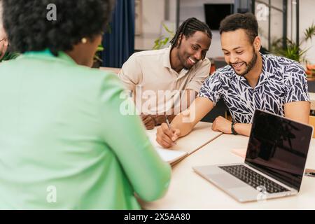Showing some team spirit. a group of unrecognizable businesspeople ...