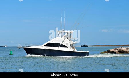 Broadside view of a beautiful white and black fishing yacht boat sails ...