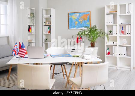 Interior of travel agency with table and different flags Stock Photo ...