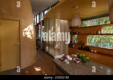 Oblong windows run down the side of the kitchen area. Straw Bale House ...
