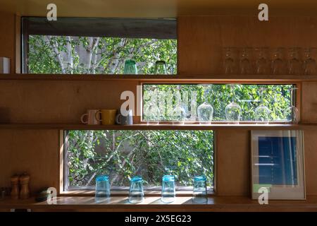 Oblong windows run down the side of the kitchen area. Straw Bale House ...