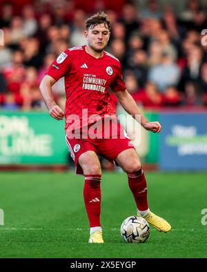 Crawley Town's Laurence Maguire and MK Dons' Alex Gilbey exchange words ...