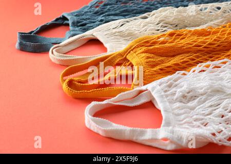 Different string bags on red background, space for text Stock Photo - Alamy