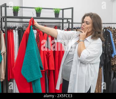 A fat woman chooses clothes in a plus size store Stock Photo - Alamy