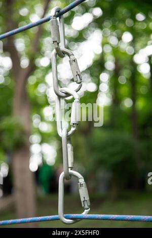 Closeup shot of a carabiner with a climbing rope and sling isolated on ...