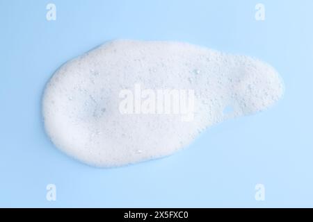 Sample of fluffy foam on light blue background, top view Stock Photo ...
