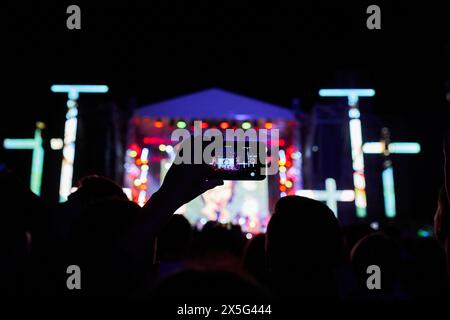 Festival goer records the concert with a smartphone on the third day of ...