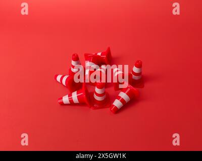 Mini plastic cones scattered on a yellow background with copy and text ...