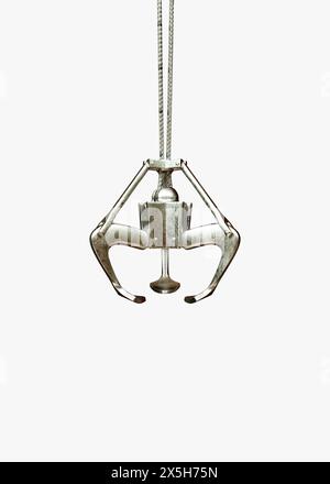 An open metal claw from a vintage arcade type grabber game connected to ...