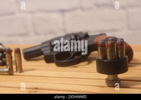 Vintage Revolver Gun With Ammo and Speed Loader Stock Photo - Alamy