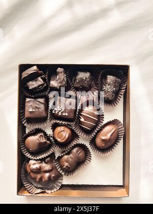Gourmet chocolates in golden box on blue back ground Stock Photo - Alamy