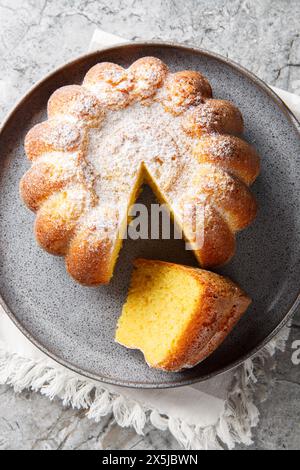 Moroccan Meskouta Orange Cake with powdered sugar close-up on a plate ...