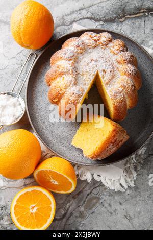 Moroccan Meskouta Orange Cake with powdered sugar close-up on a plate ...