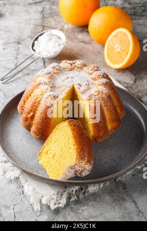 Moroccan Meskouta Orange Cake with powdered sugar close-up on a plate ...