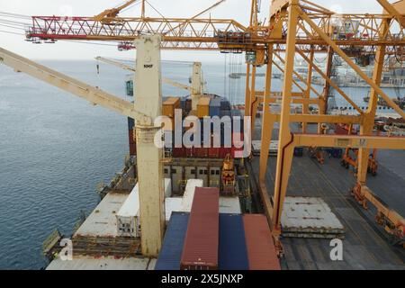 Container vessel equipped with ship cranes during cargo operation ...