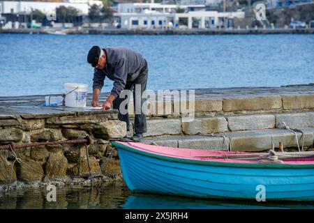 Greece, Mykonos. A fisherman guts fish. (Editorial use only Stock Photo ...