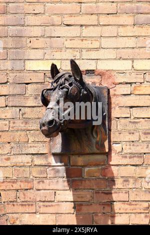 Metal sculpture of horse head, brick wall of colonial building, Bloor ...