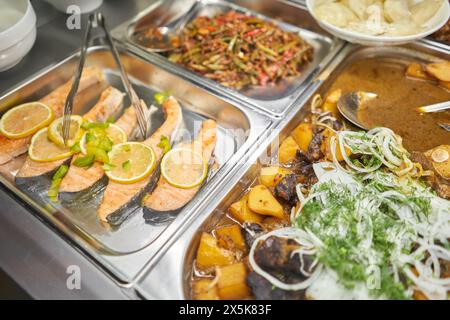 Salmon fillet. Various hot dishes . Glass Showcase in a buffet or self ...