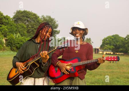 Two young women playing guitars Stock Photo - Alamy