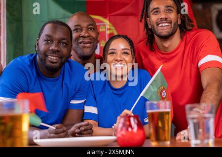 Friends holding national flags during world cup competition Stock Photo ...