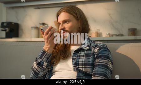 Smiling male doctor answer phone call, talking on cellphone, wearing ...