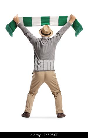 Back view of a man cheering with a scarf in front of a tv screen ...